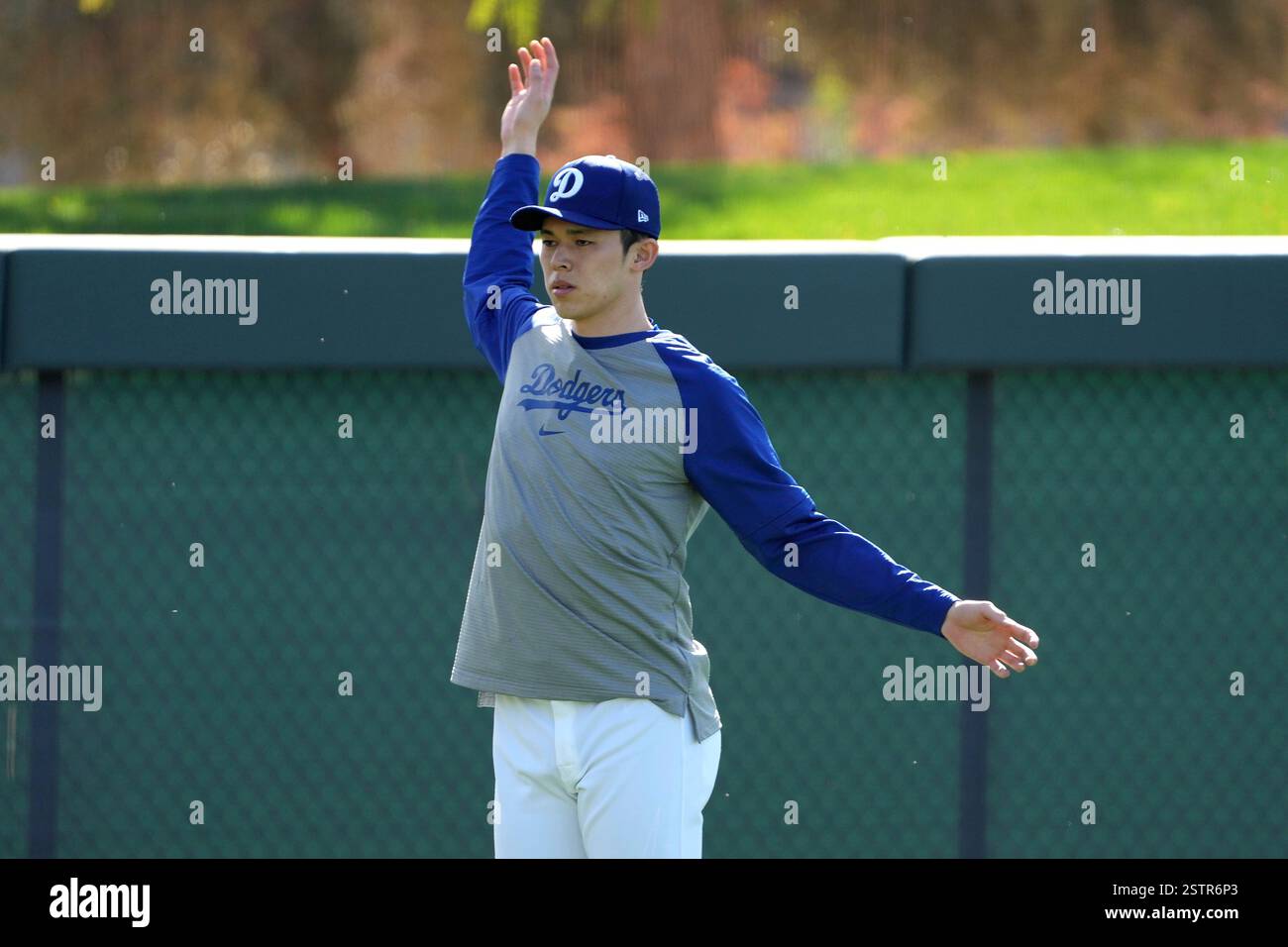 Los Angeles Dodgers pitcher Roki Sasaki warms up before his first live ...