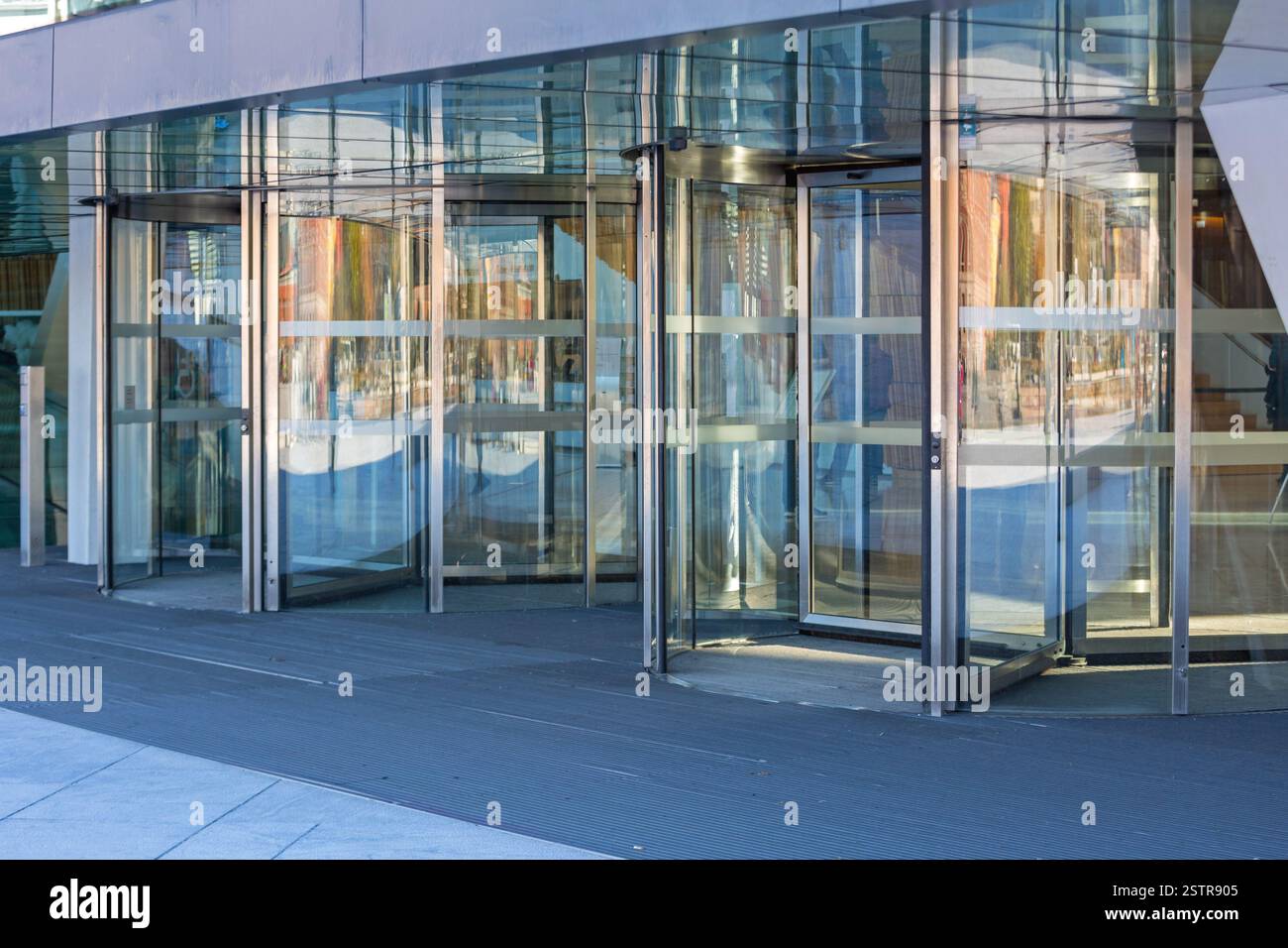 Automatic revolving doors at modern building entrance hi-res stock ...