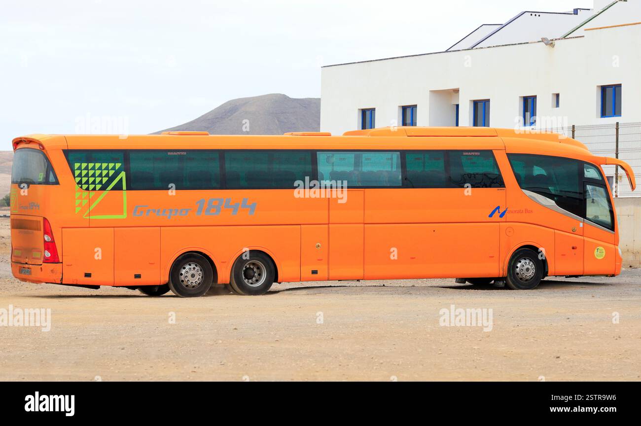 Bright orange coach in a car park, Fuerteventura, Canary Islands, Spain ...