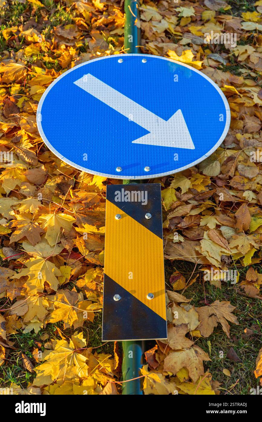 Direction arrow traffic sign pole at ground hi-res stock photography ...