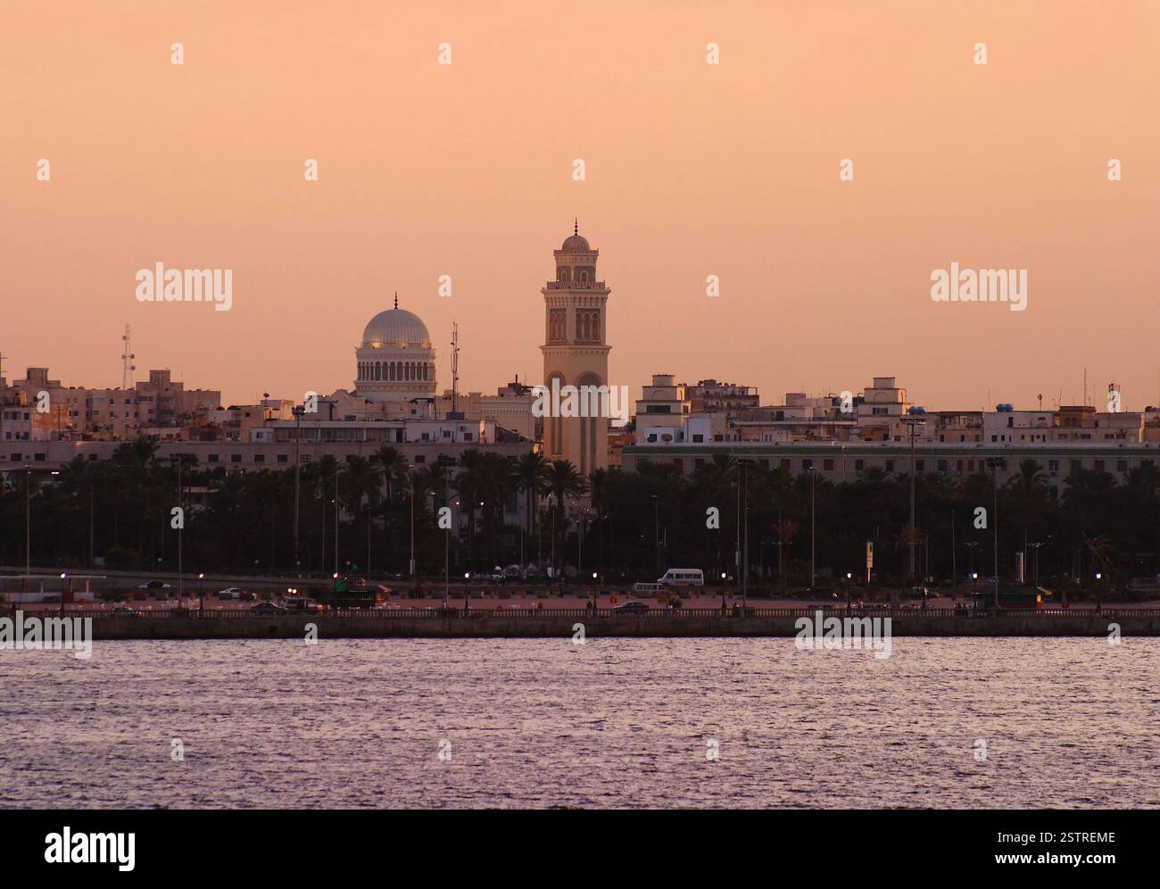 Libya. The skyline of Tripoli at dusk. Dome and minaret of the World ...
