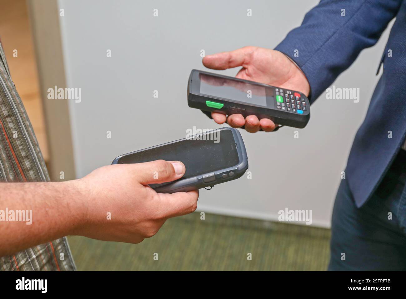 Two man holding portable computer devices equipment hi-res stock ...