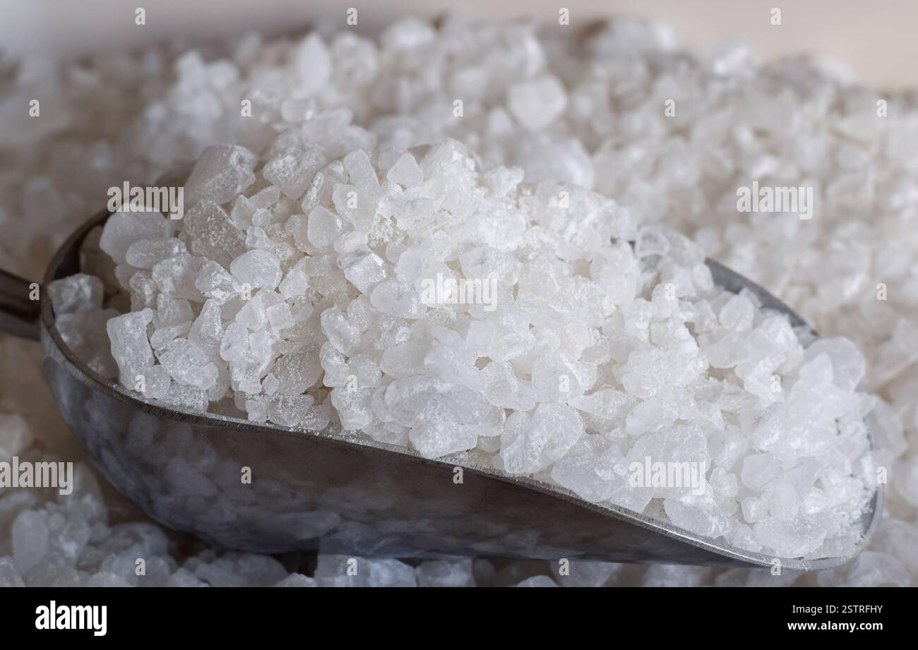 Large crystals water softener salt in a scoop closeup Stock Photo - Alamy
