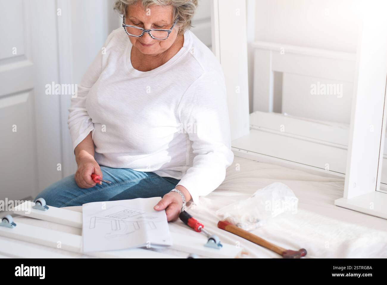 Woman reading instruction assembling hi-res stock photography and ...