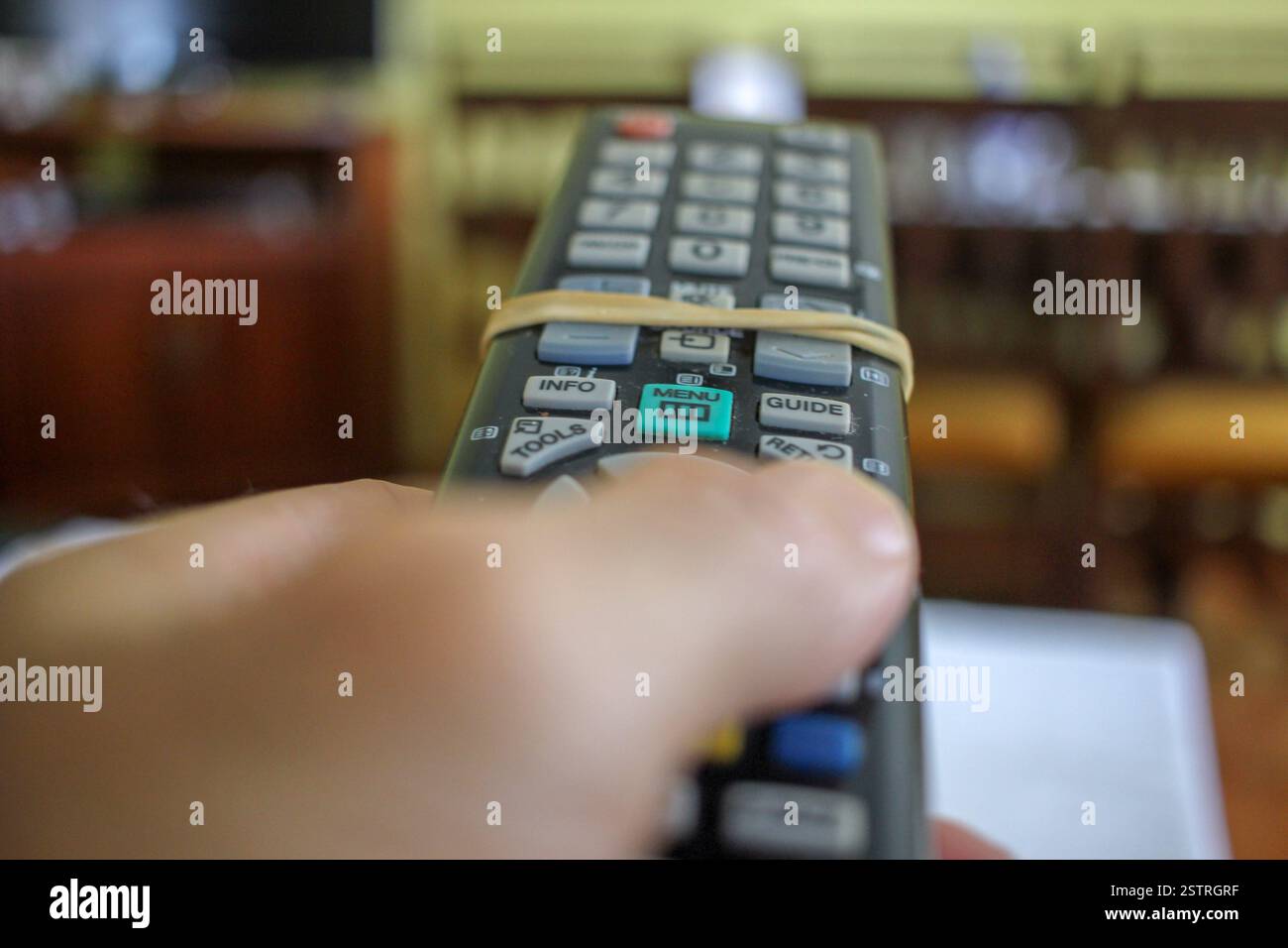 pressing the remote control in the living room. The one who has got the ...