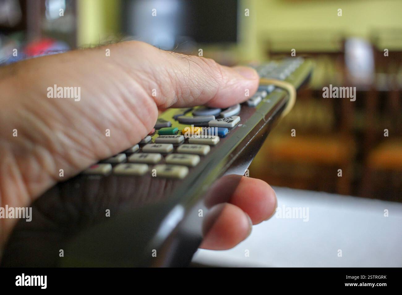 pressing the button on the tv remote at home Stock Photo - Alamy