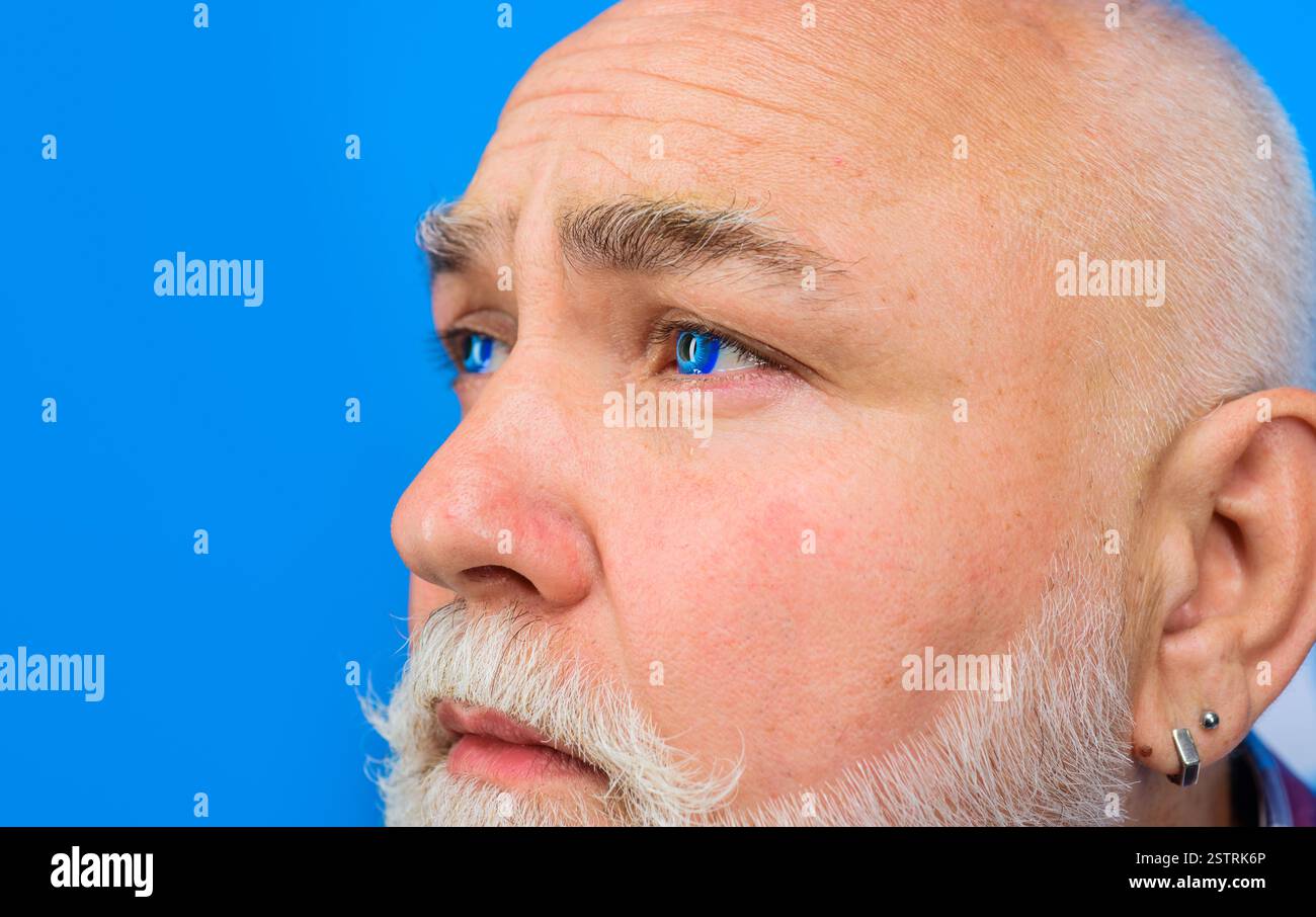 Closeup portrait of male eyes with blue contact lenses and tears ...