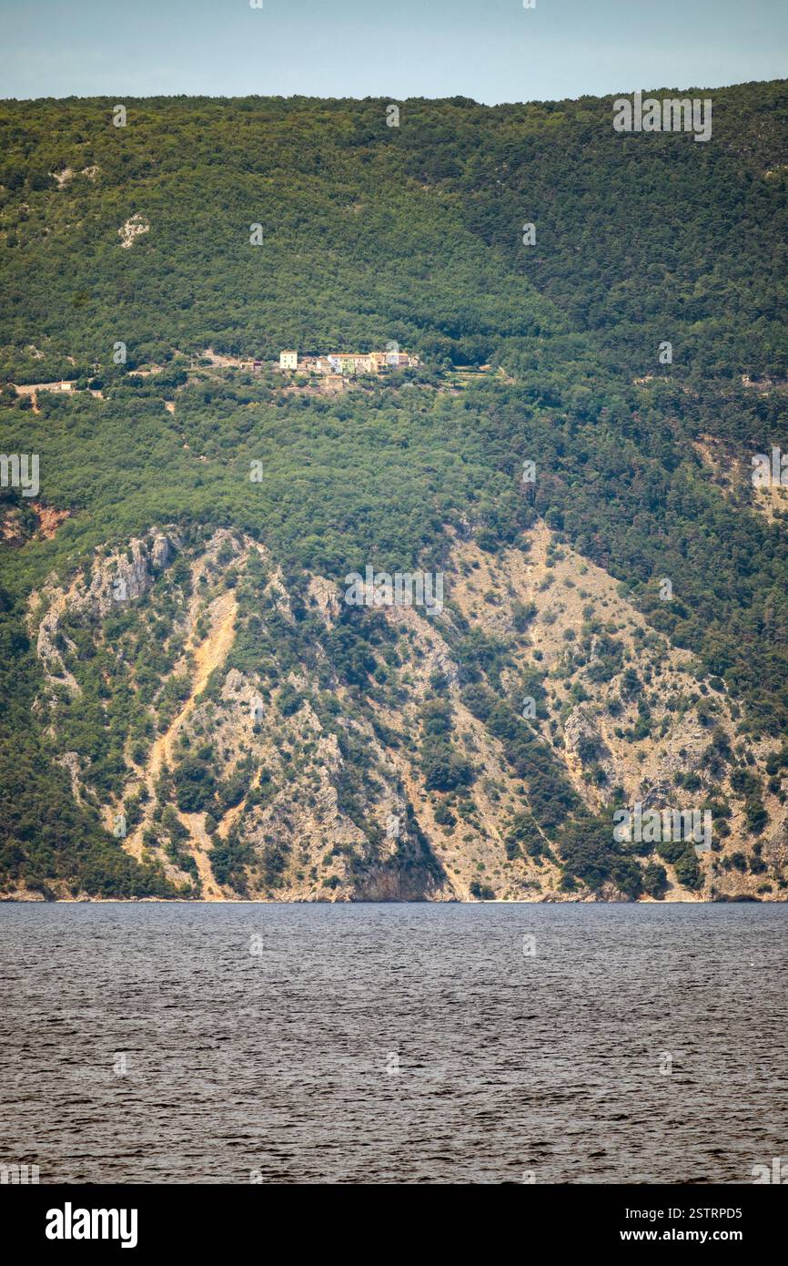 Small village on Cres island built on the steep slope above Adriatic ...