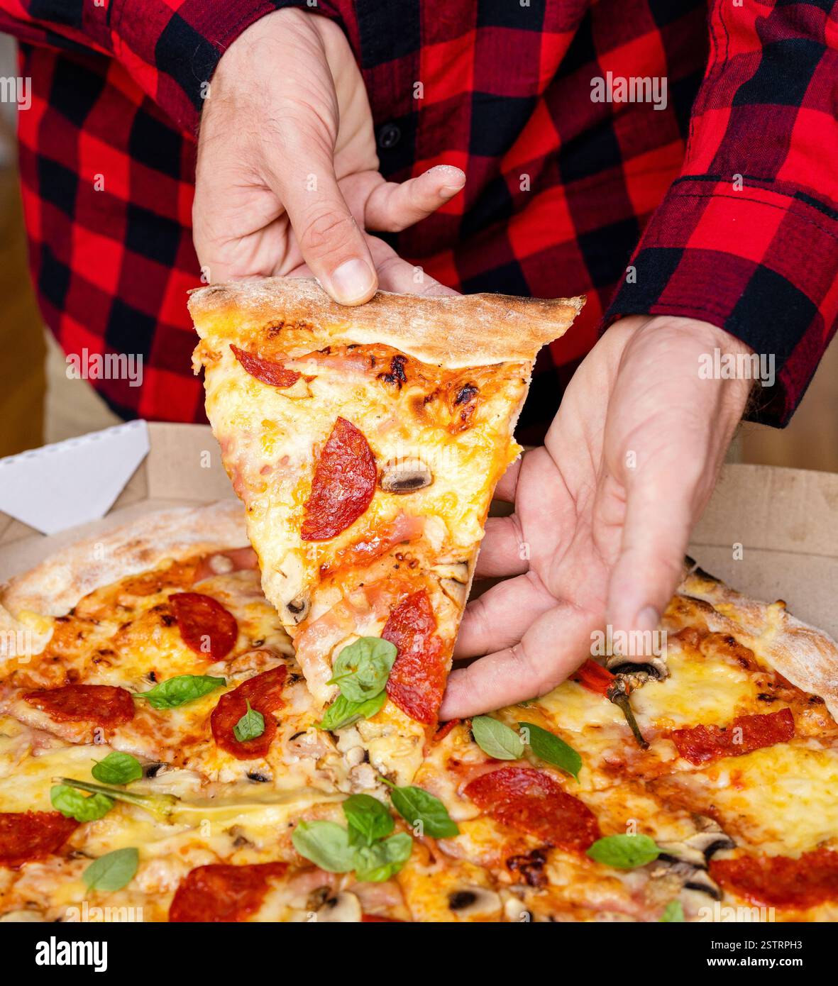 Holding pizza slice hi-res stock photography and images - Alamy