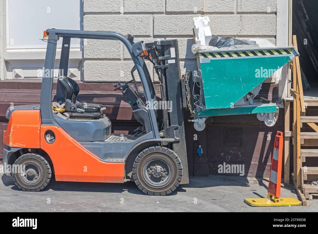 Forklift truck with skip container at construction site hi-res stock ...