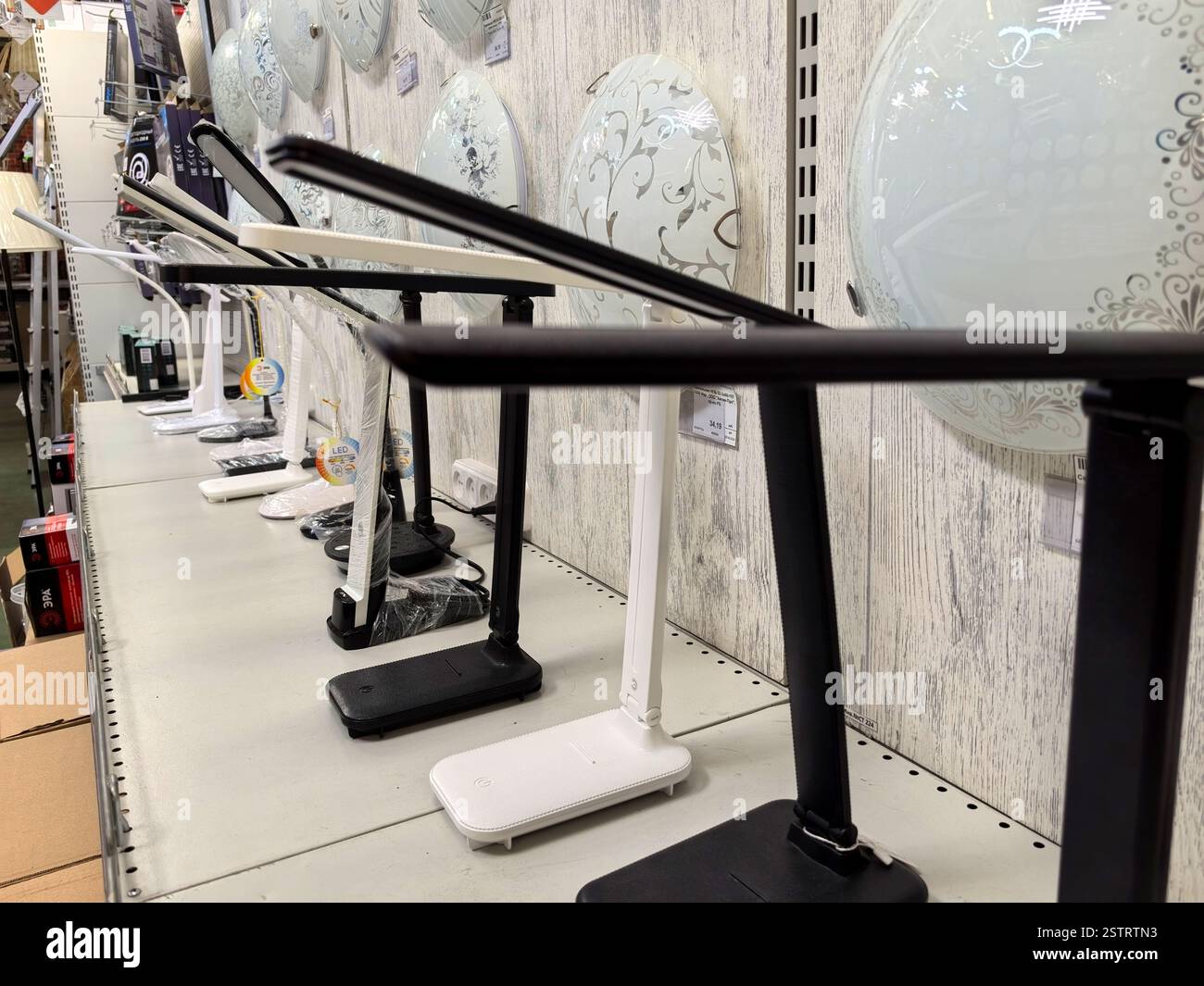 A row of stylish desk lamps in contrasting colors showcases ...