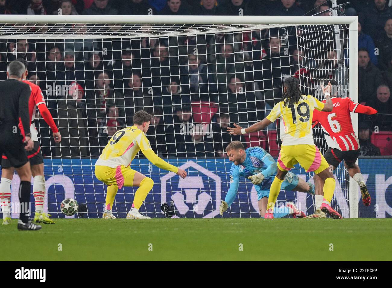 PSV's Ryan Flamingo, right, scores his side's third goal during the Champions League playoff ...