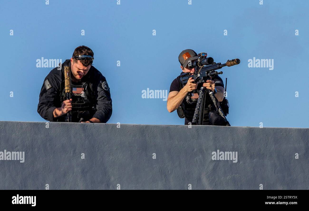 Secret Service snipers are seen positioned on the roof of a building ...