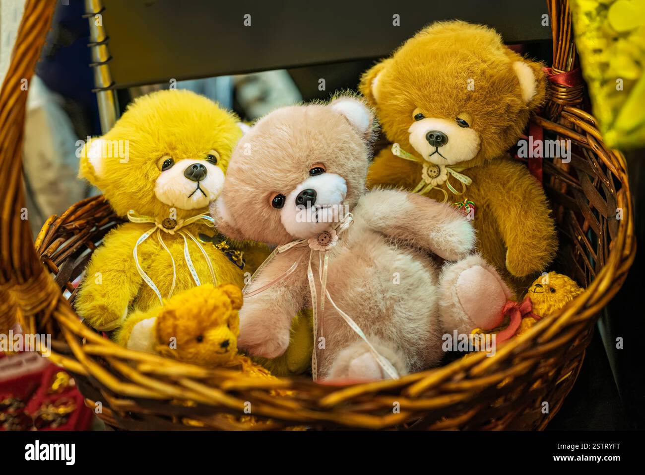 Soft and colorful teddy bears arranged in woven basket. Three plush ...