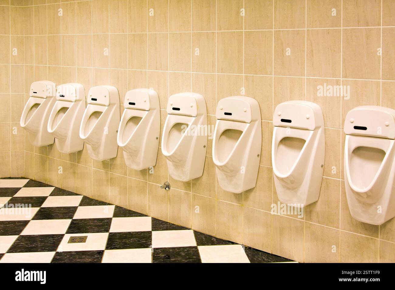 Interior of men toilet with urinals in line hi-res stock photography ...