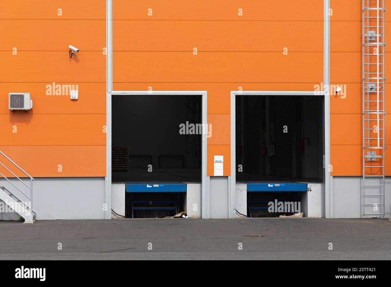 Two Cargo Doors at Orange Distribution Warehouse Stock Photo - Alamy