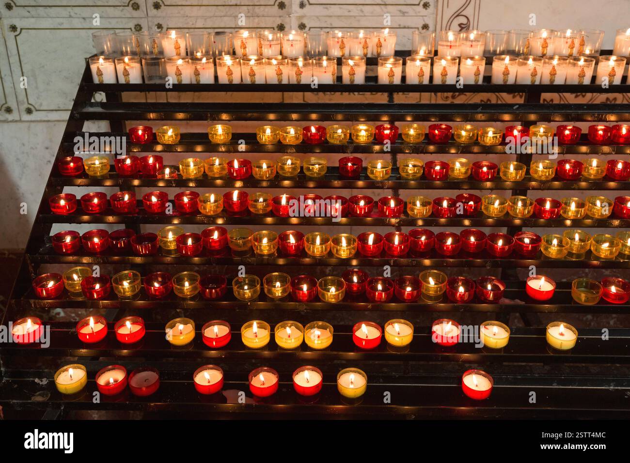 Votive candles prayer rack hi-res stock photography and images - Alamy