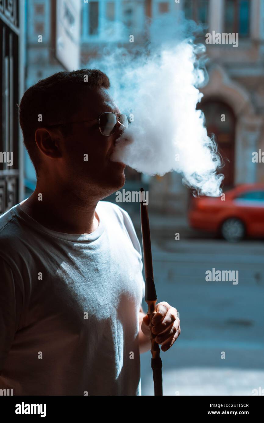 Silhouette of hookah maker blowing smoke in the dark Stock Photo - Alamy