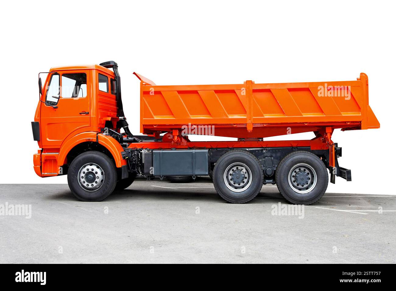 Side view of big orange truck tipper Stock Photo - Alamy