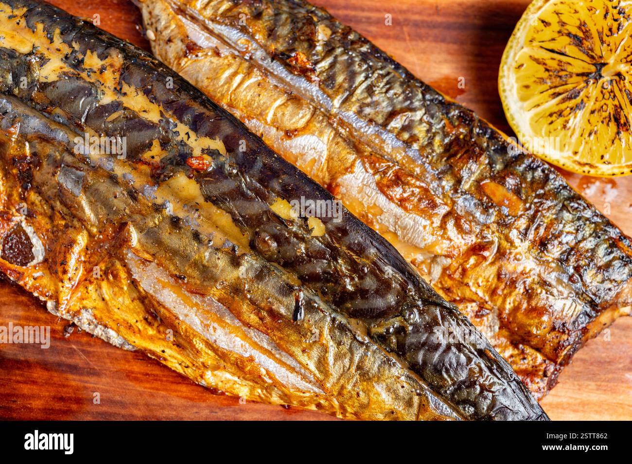 Grilled mackerel fillets exhibit a golden brown exterior with crispy ...