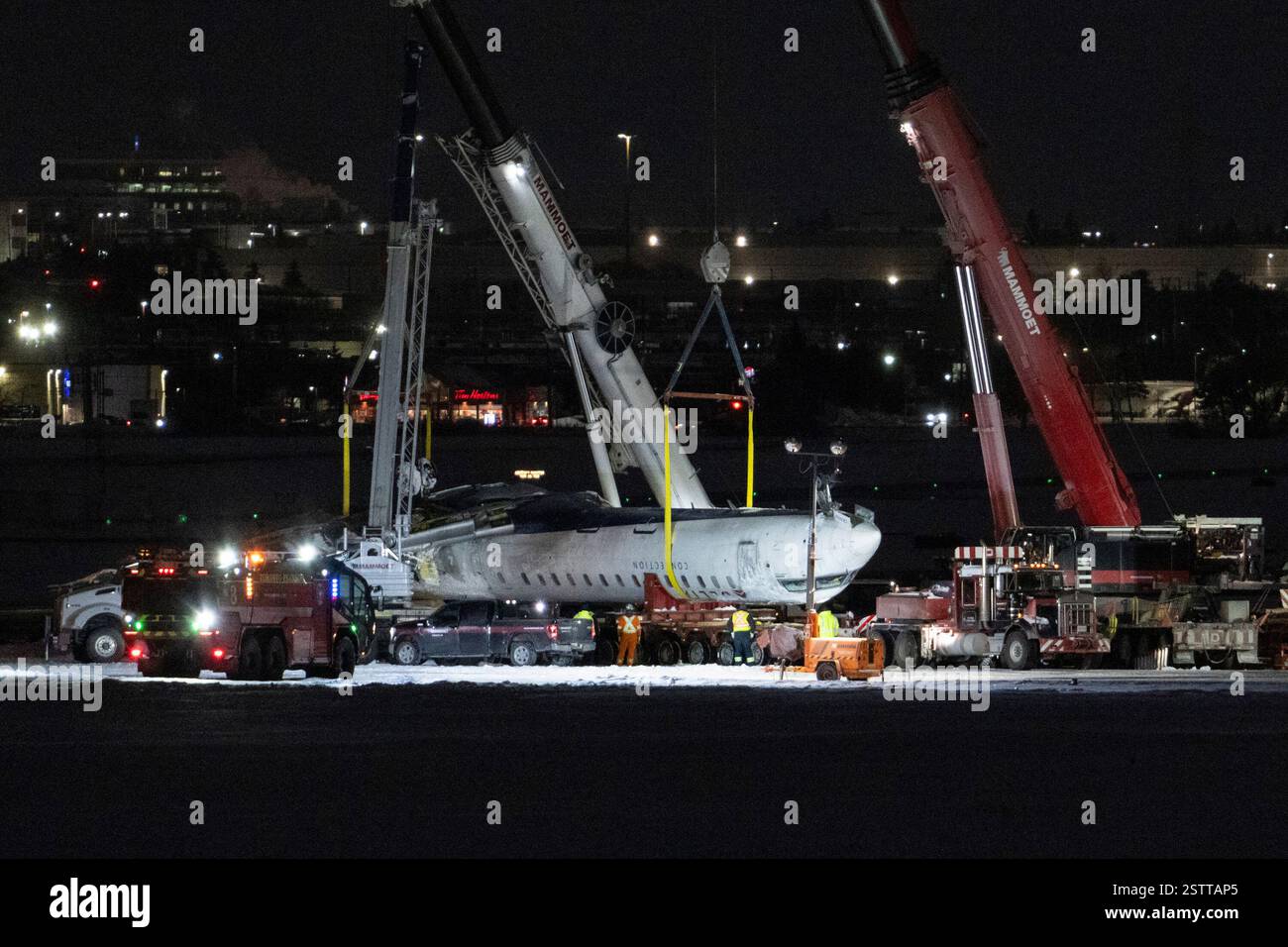 Cranes lift the wreckage of Delta flight 4819 from the runway at ...