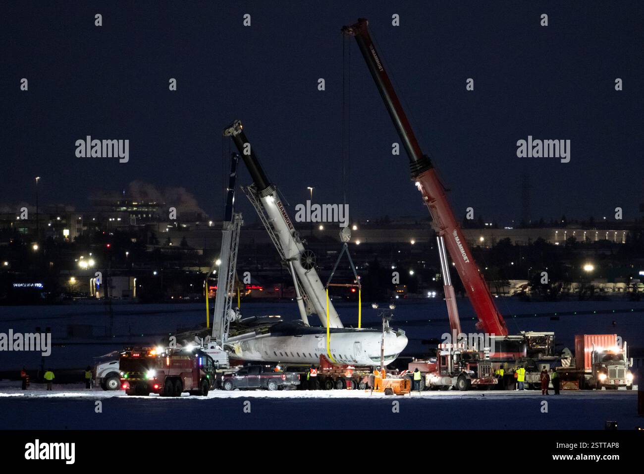 Cranes lift the wreckage of Delta flight 4819 from the runway at ...