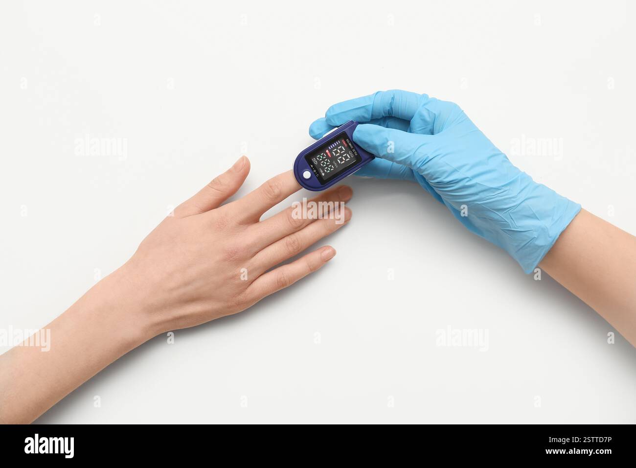 Doctor checking pulse from young woman with pulse oximeter on white ...