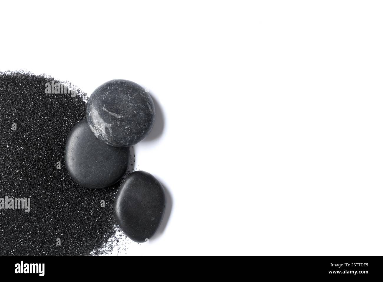 Black beach sand with pebbles on white background Stock Photo - Alamy