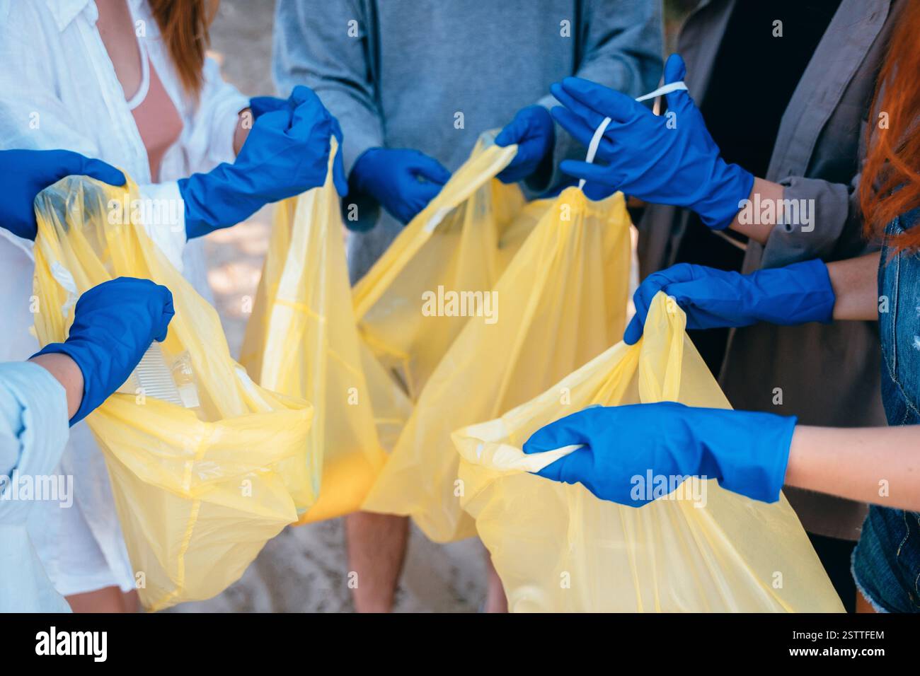 Group of activists friends collecting plastic waste on the beach ...