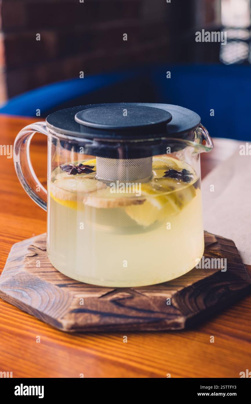 The kettle is on the table in the cafe in it is clogged with herbal tea ...