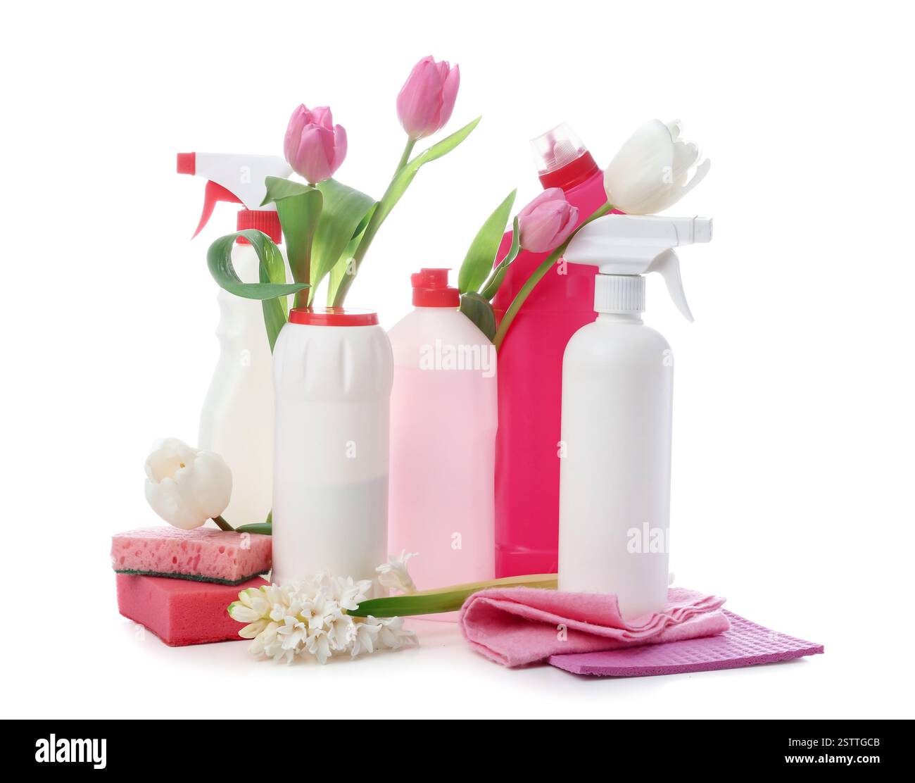Bottles of detergents with rags, sponges and spring flowers on white ...