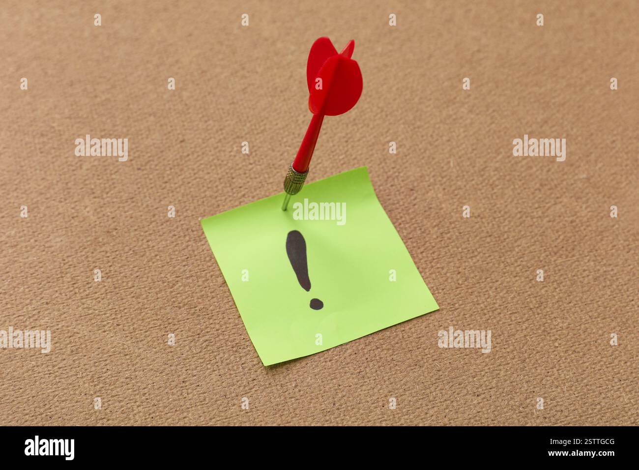 Green sticky note with exclamation mark pinned on board Stock Photo - Alamy