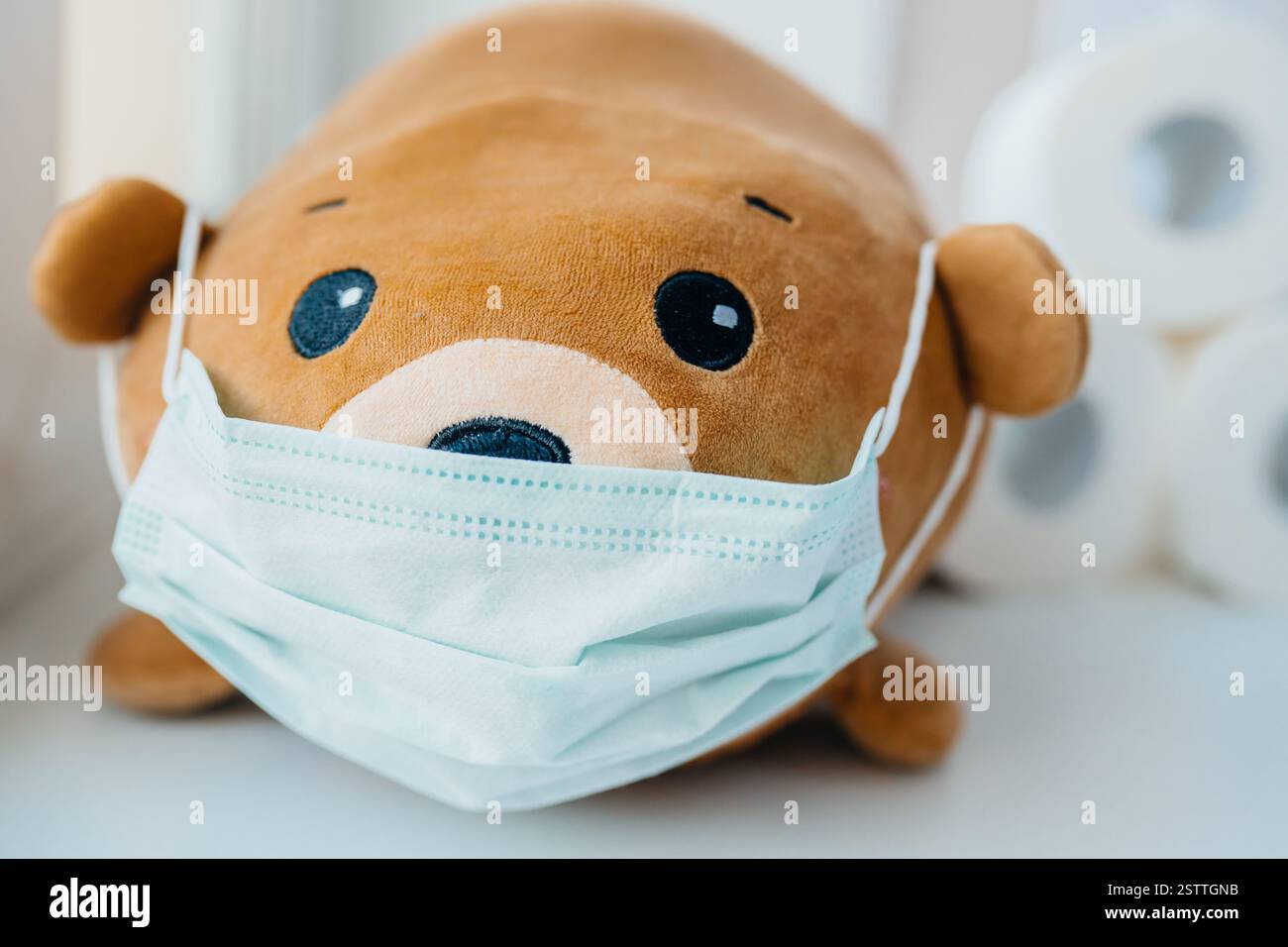 Disposable medical protective face mask on brown teddy bear Stock Photo ...