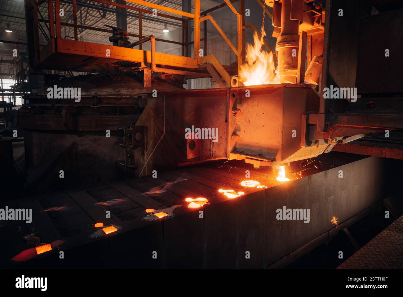 Molten metal pouring into casting molds in a foundry Stock Photo - Alamy