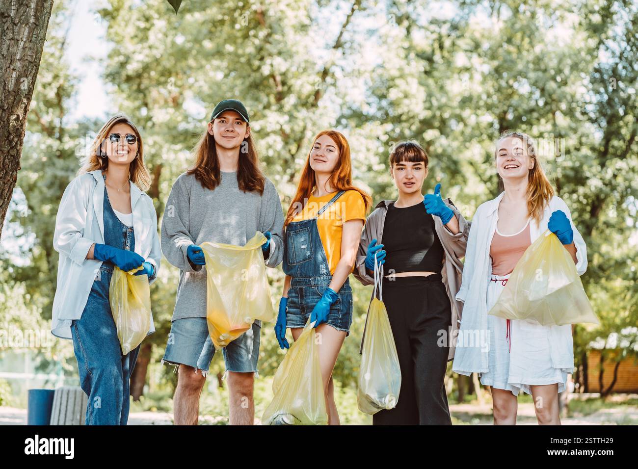 Group of activists friends collecting plastic waste at the park ...