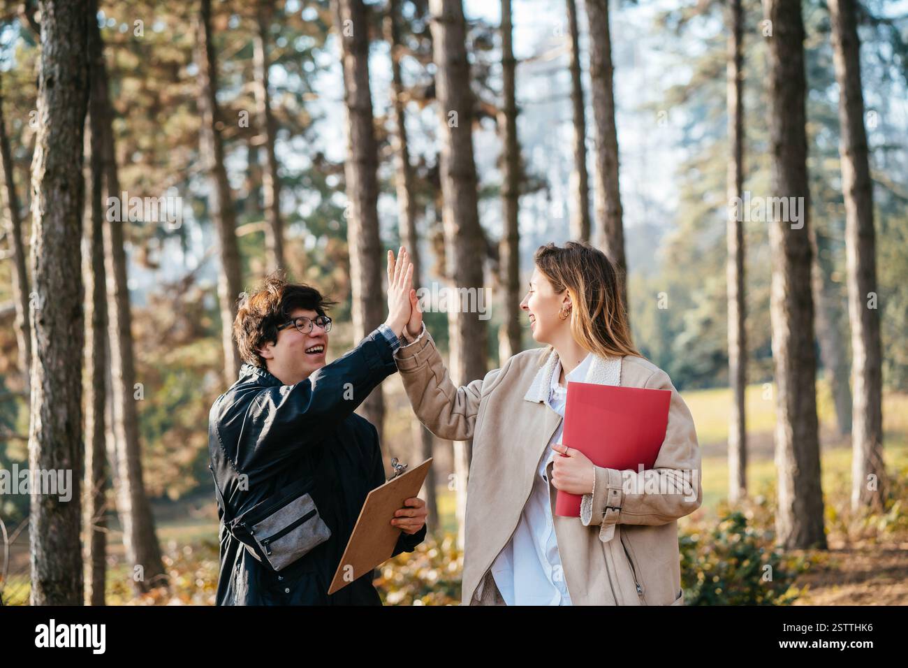 Man give high five woman in the forest Stock Photo - Alamy