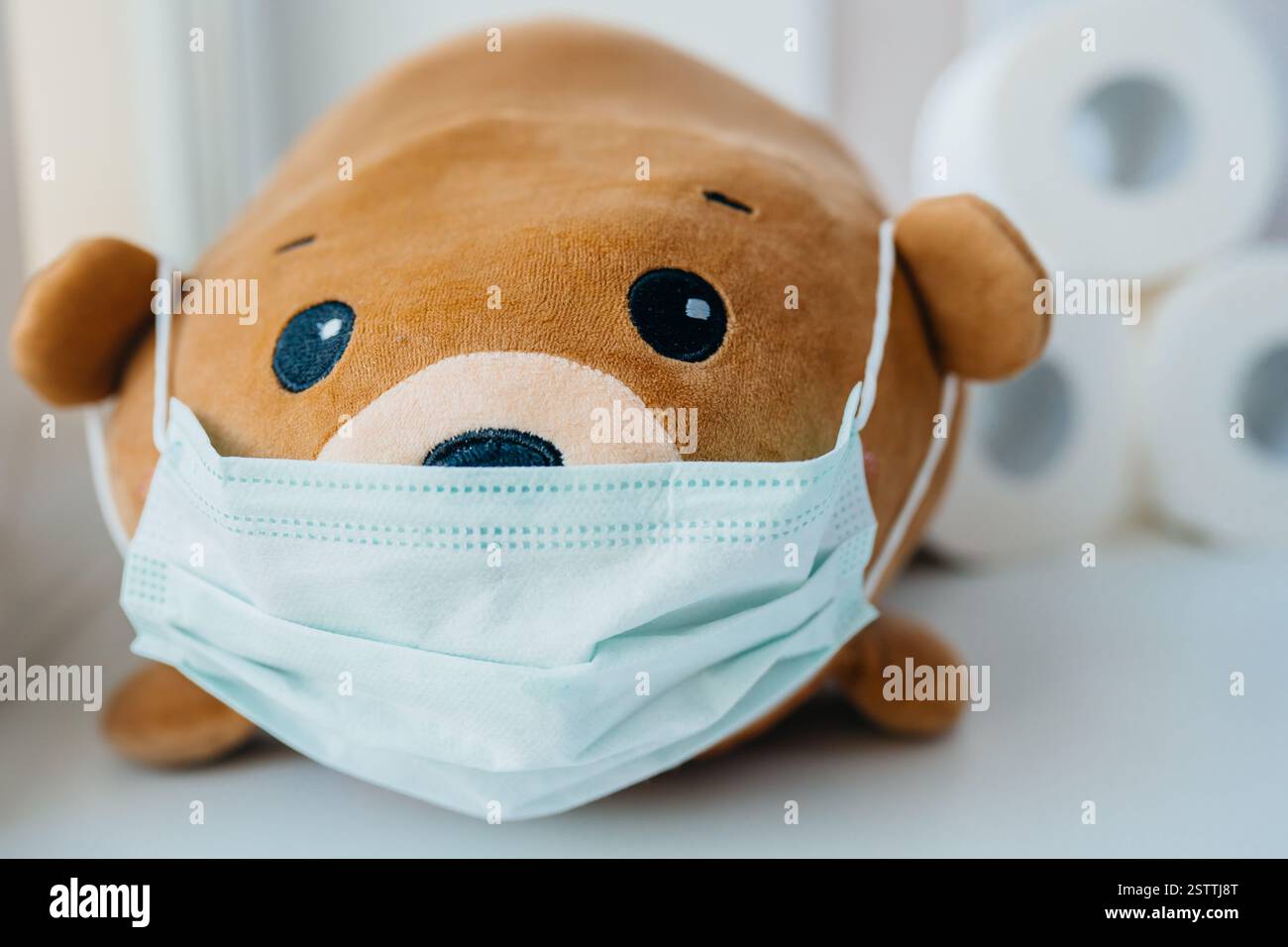 Disposable medical protective face mask on brown teddy bear Stock Photo ...