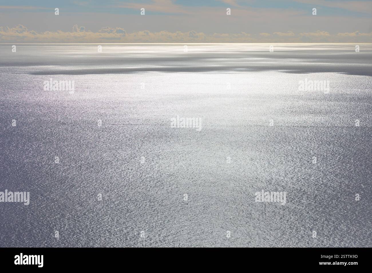 Vast expanse of the ocean with sunlight reflecting off water surface ...