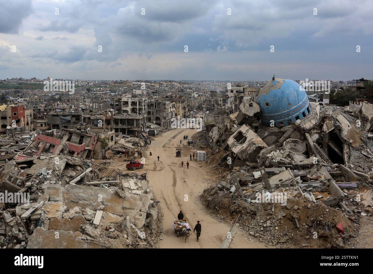 Gaza. 19th Feb, 2025. Palestinians are pictured among destroyed houses ...