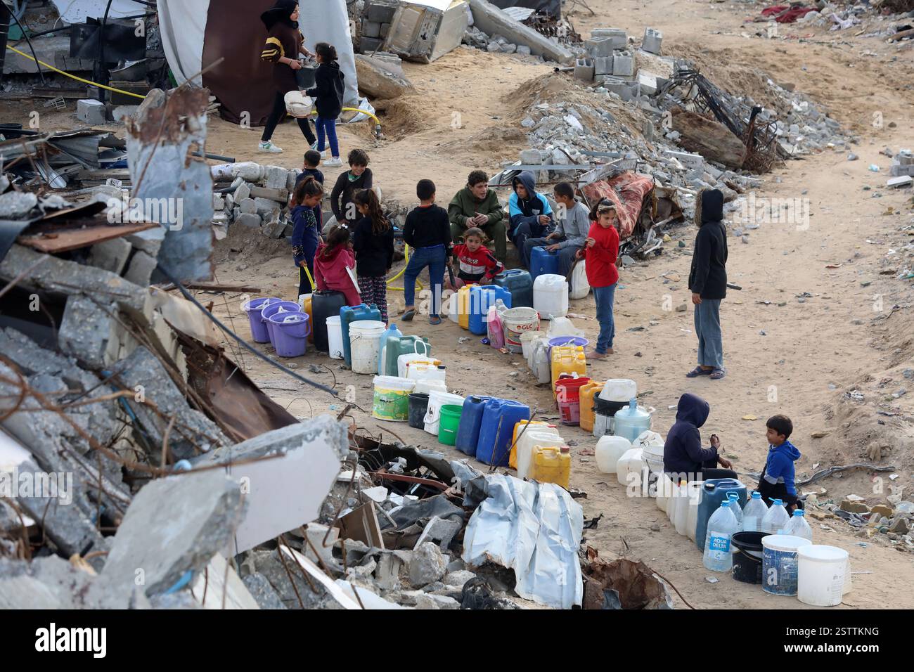Gaza. 19th Feb, 2025. Palestinians are pictured among destroyed houses ...