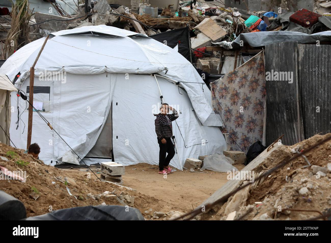 Gaza. 19th Feb, 2025. A Palestinian kid is pictured near a tent among ...