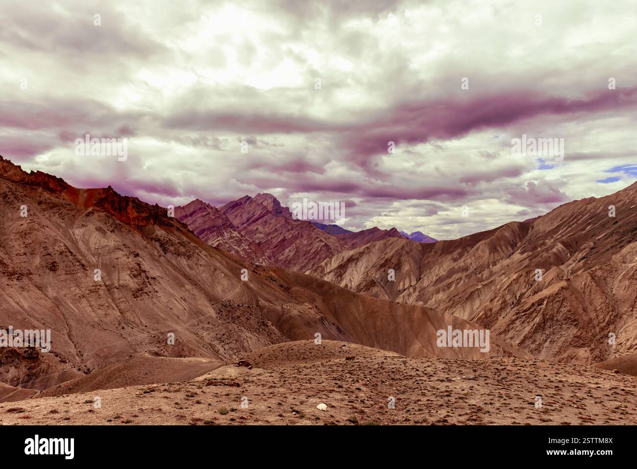 Thick monsoon clouds hang over the semi-desert landscape of the Zanskar ...
