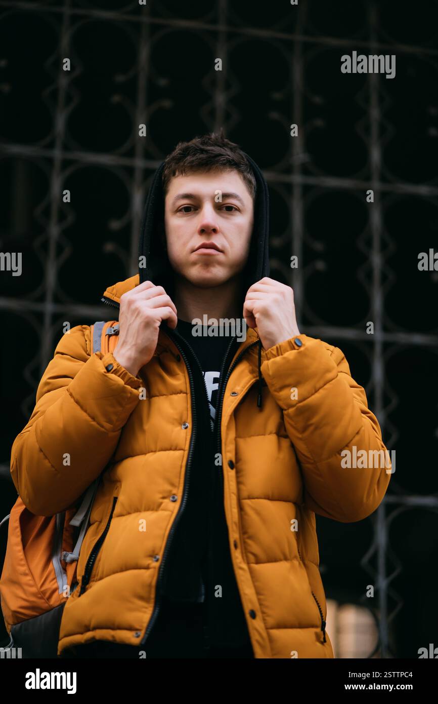 Young man yellow backpack stands hi-res stock photography and images ...
