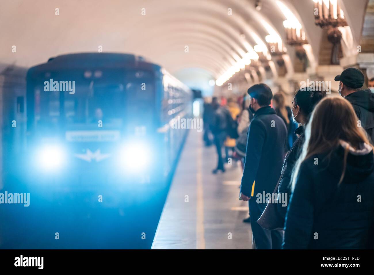 People wait at a subway station in Kiev. Subway train arrives at metro ...