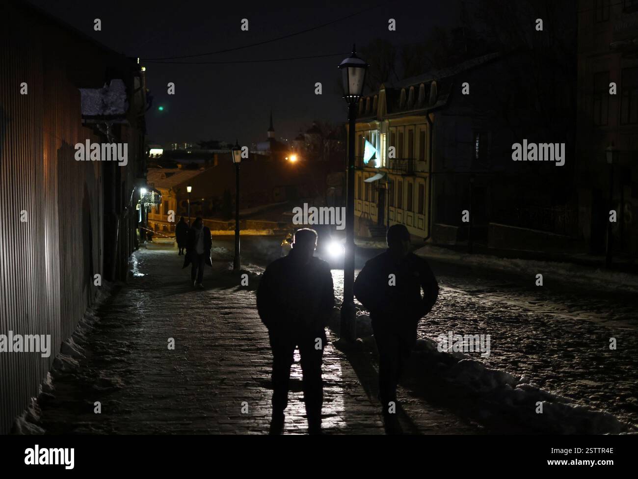 A photo shows dimly lit streets of Kyiv as street lights go out due to ...