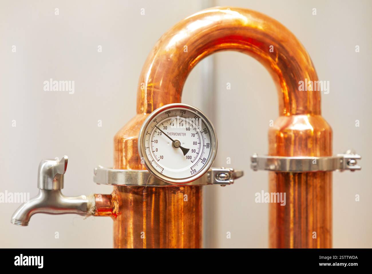 Alcohol temperature gauge at copper still pipe distillery brewery hi ...