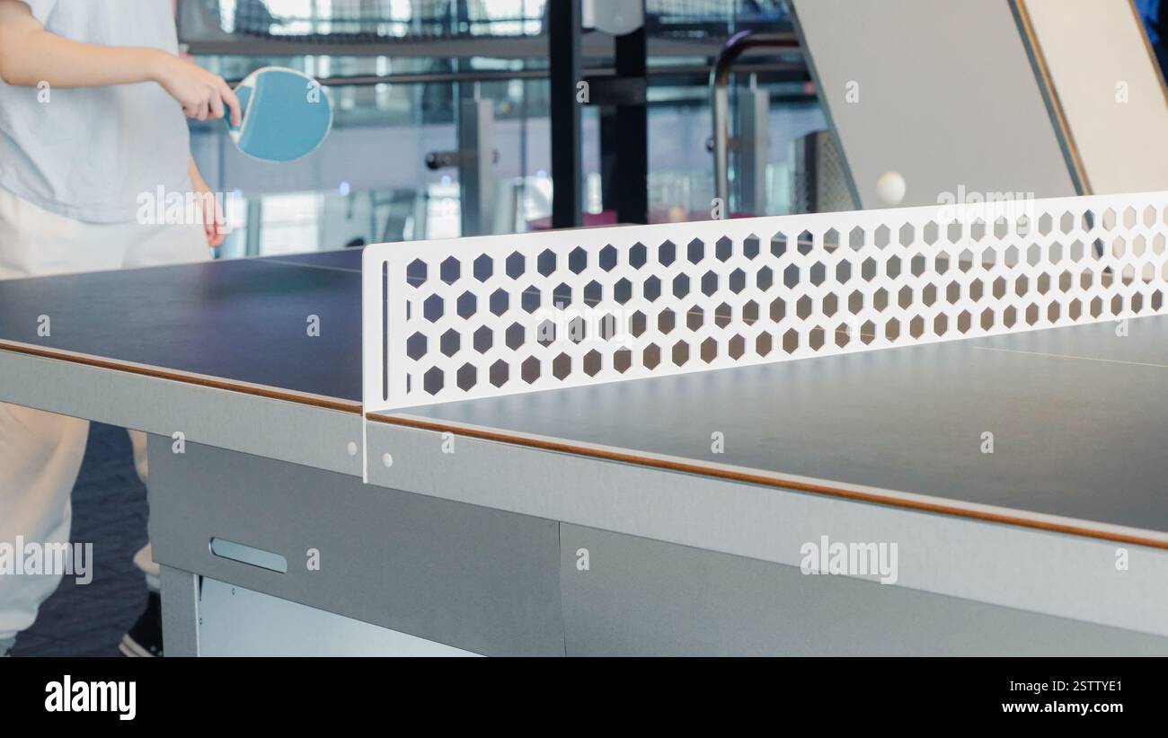 Engaging in a Friendly Ping Pong Tournament in the Modern Office Space ...