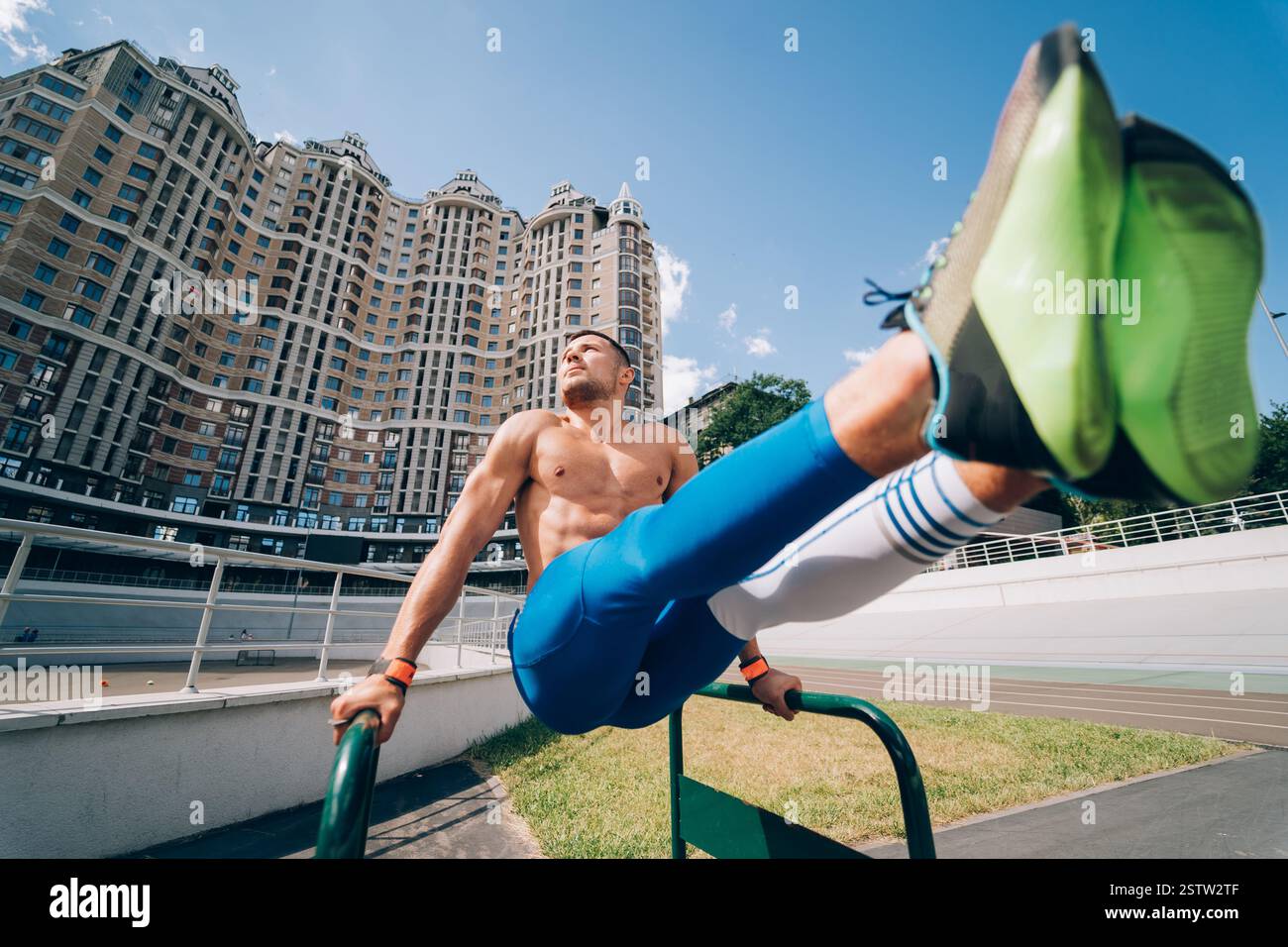 Strong man doing exercises on uneven bars in outdoor street gym Stock ...