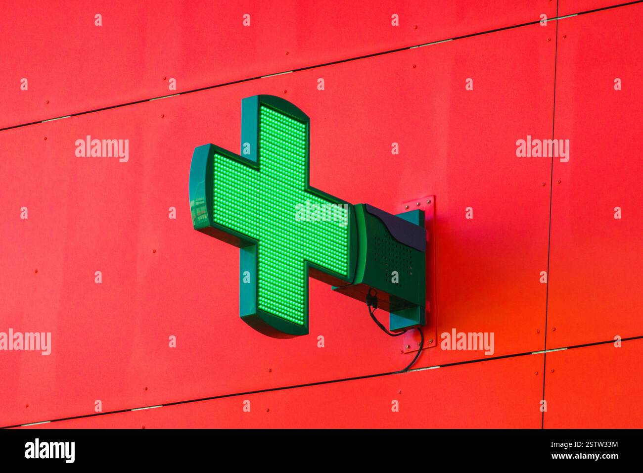 Green pharmacy sign on red wall Stock Photo - Alamy