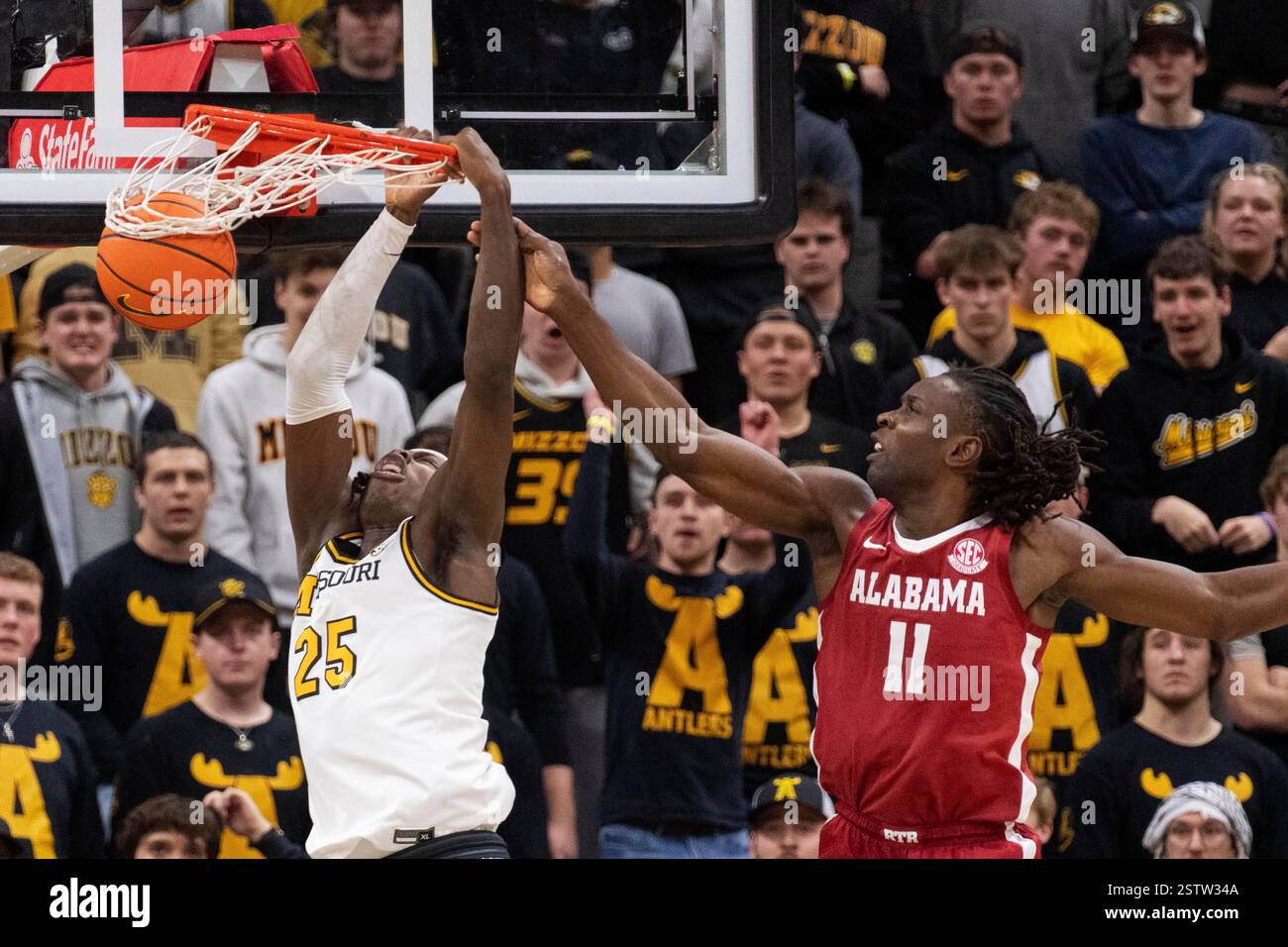 Missouri's Mark Mitchell (25) is fouled as he dunks by Alabama's ...